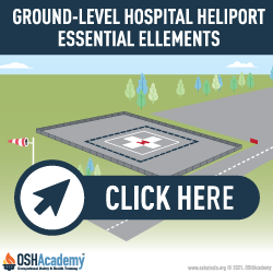 worker in safety vest refueling a helicopter. Another man in a yellow ...